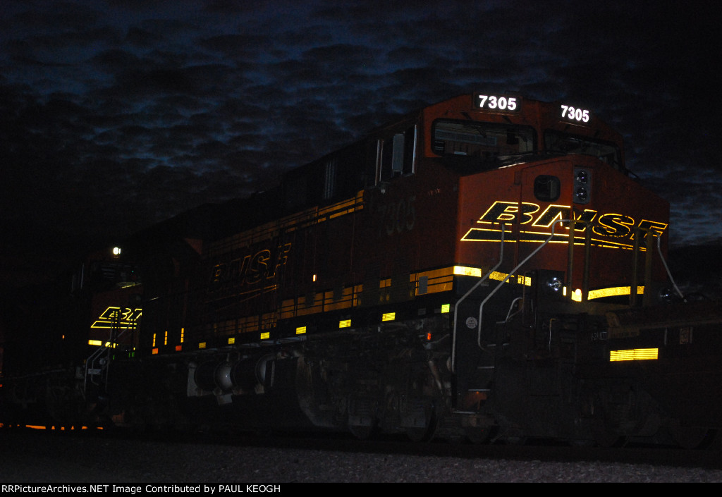 BNSF 7305 lead DPU and BNSF 6637 reflect the flash off their BNSF Swoosh reflective Logo as Dusk ...